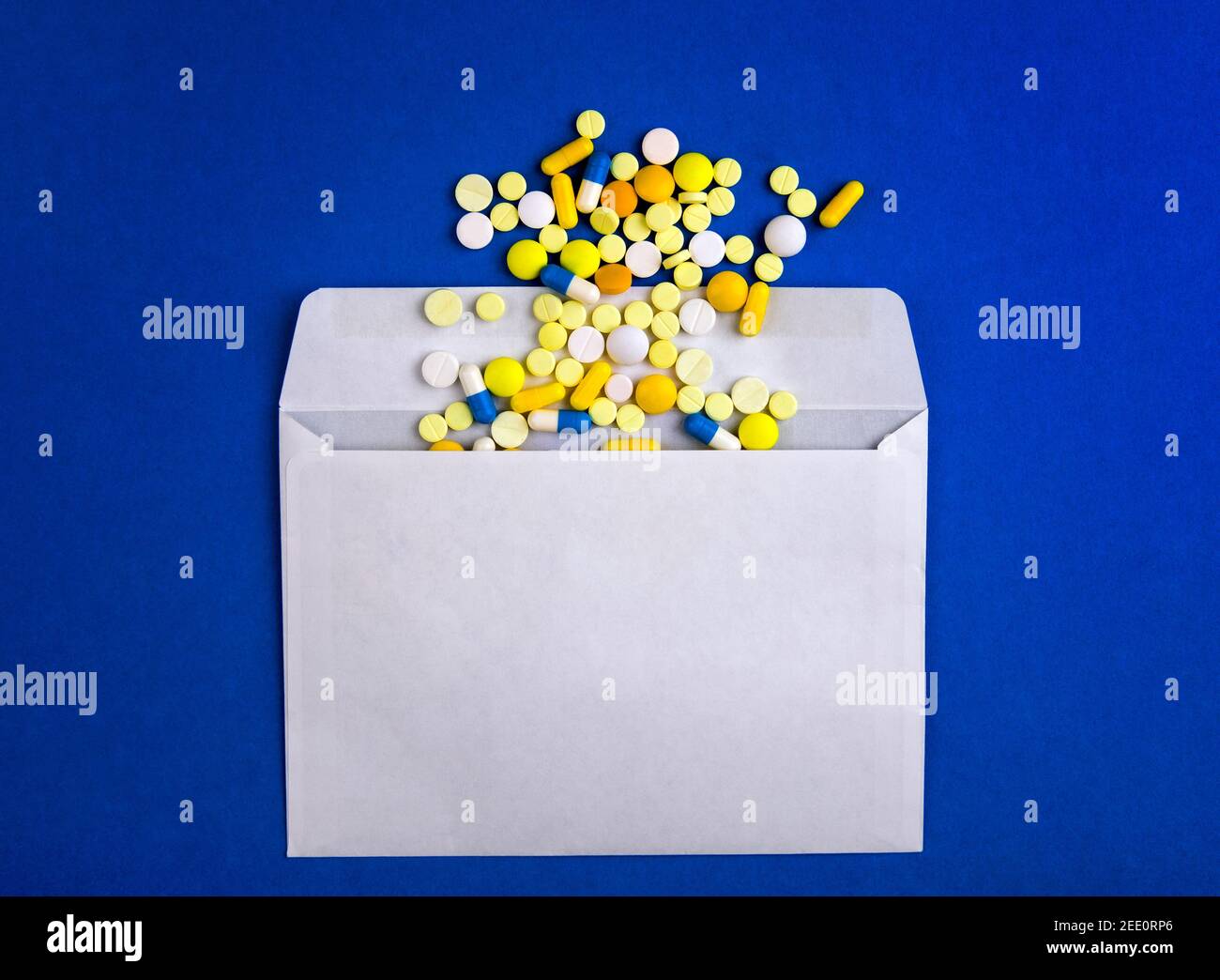 Pills with an Envelope on the Blue Paper Background closeup Stock Photo ...