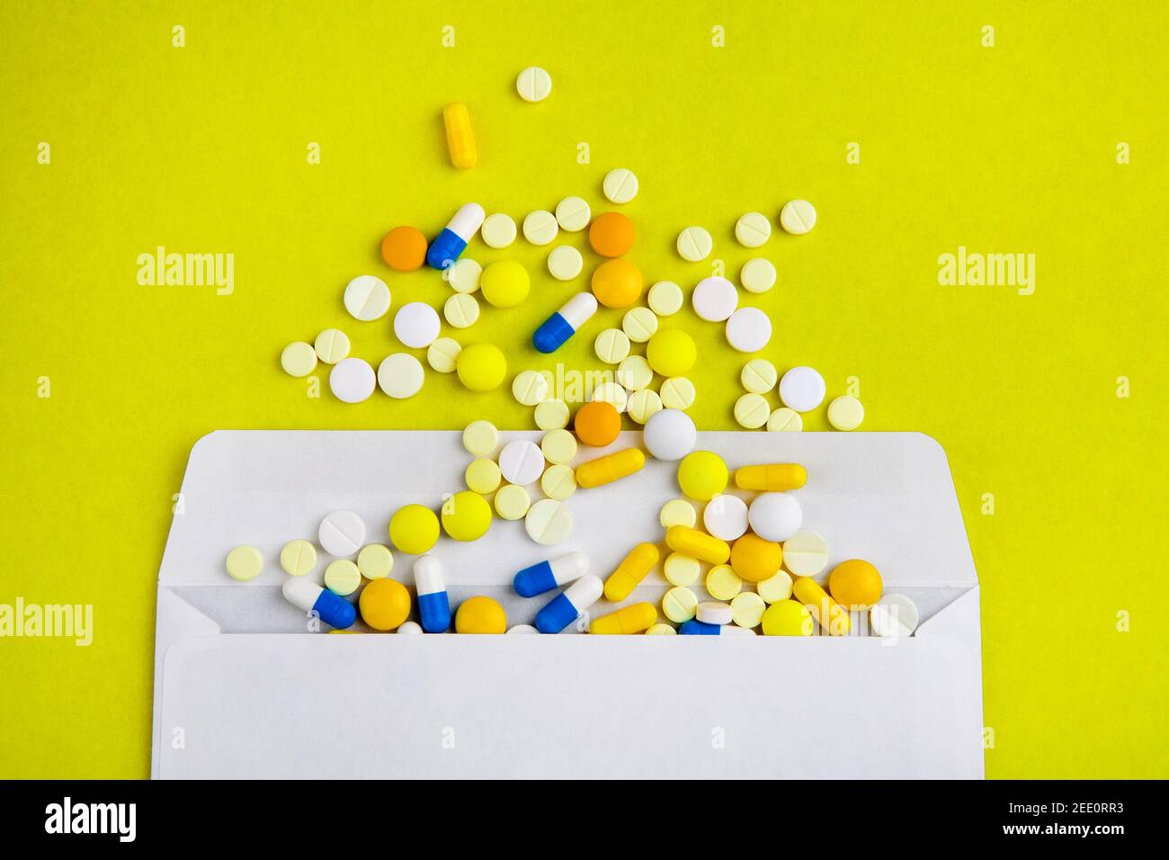 Pills with an Envelope on the Yellow Paper Background closeup Stock ...