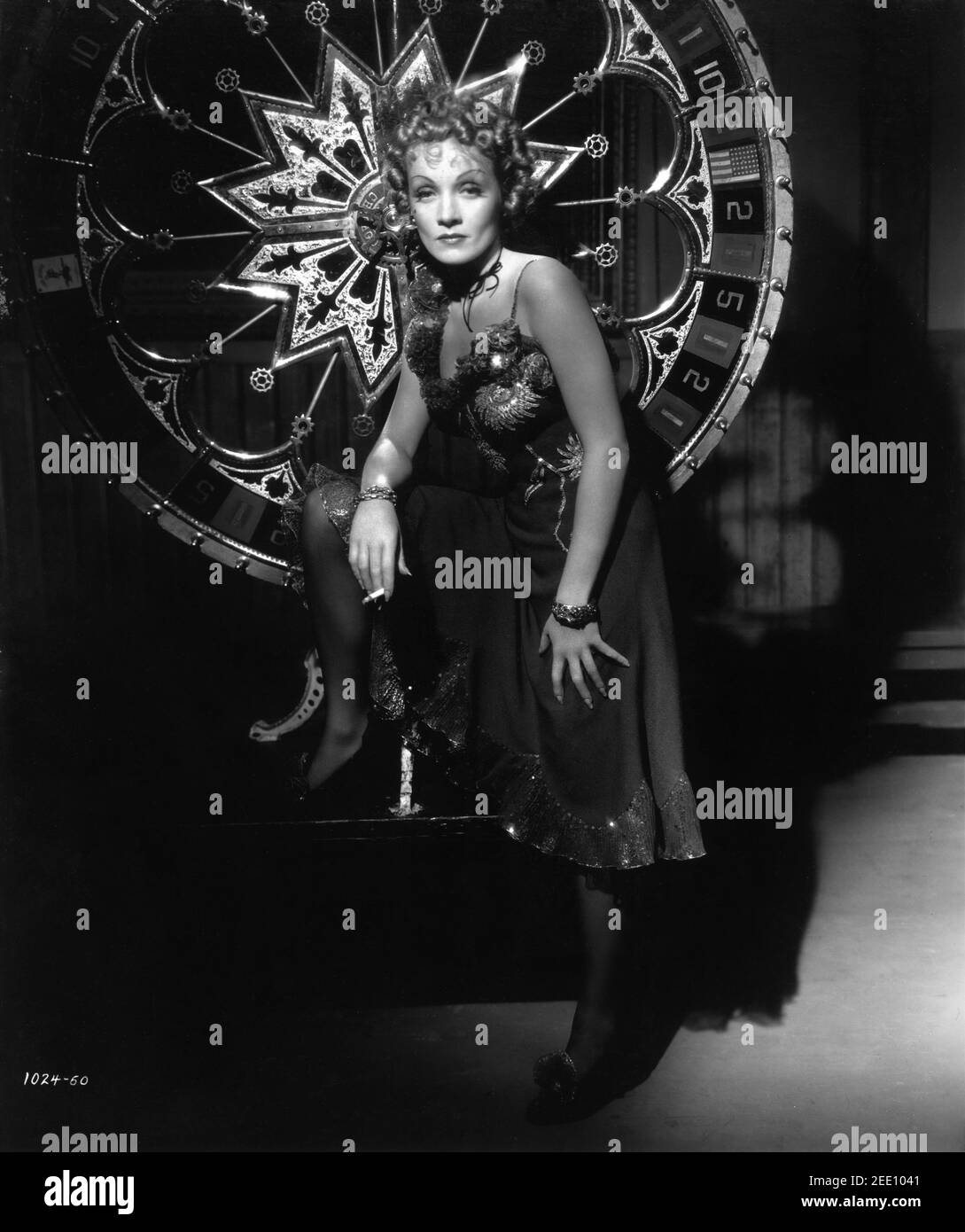 MARLENE DIETRICH publicity pose by giant roulette wheel in DESTRY RIDES ...