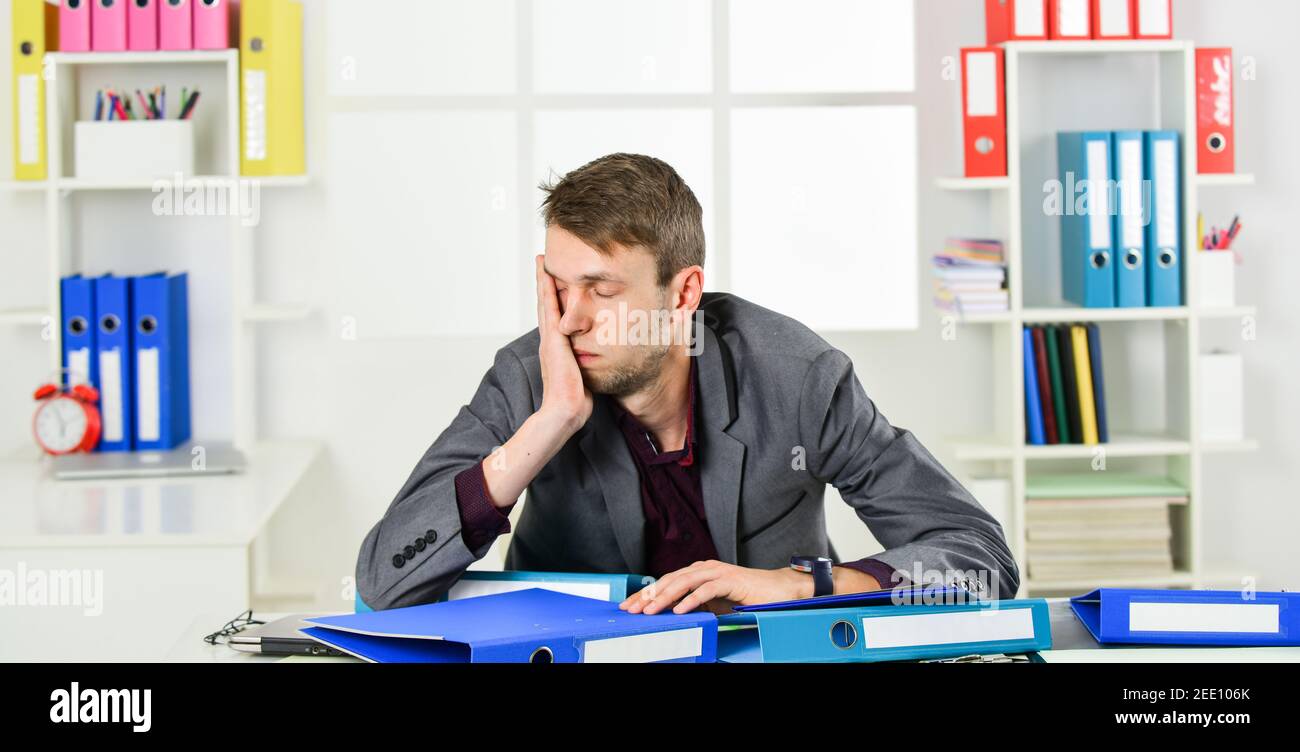 so exhausted. man wear office suit. male realtor has hard working day ...