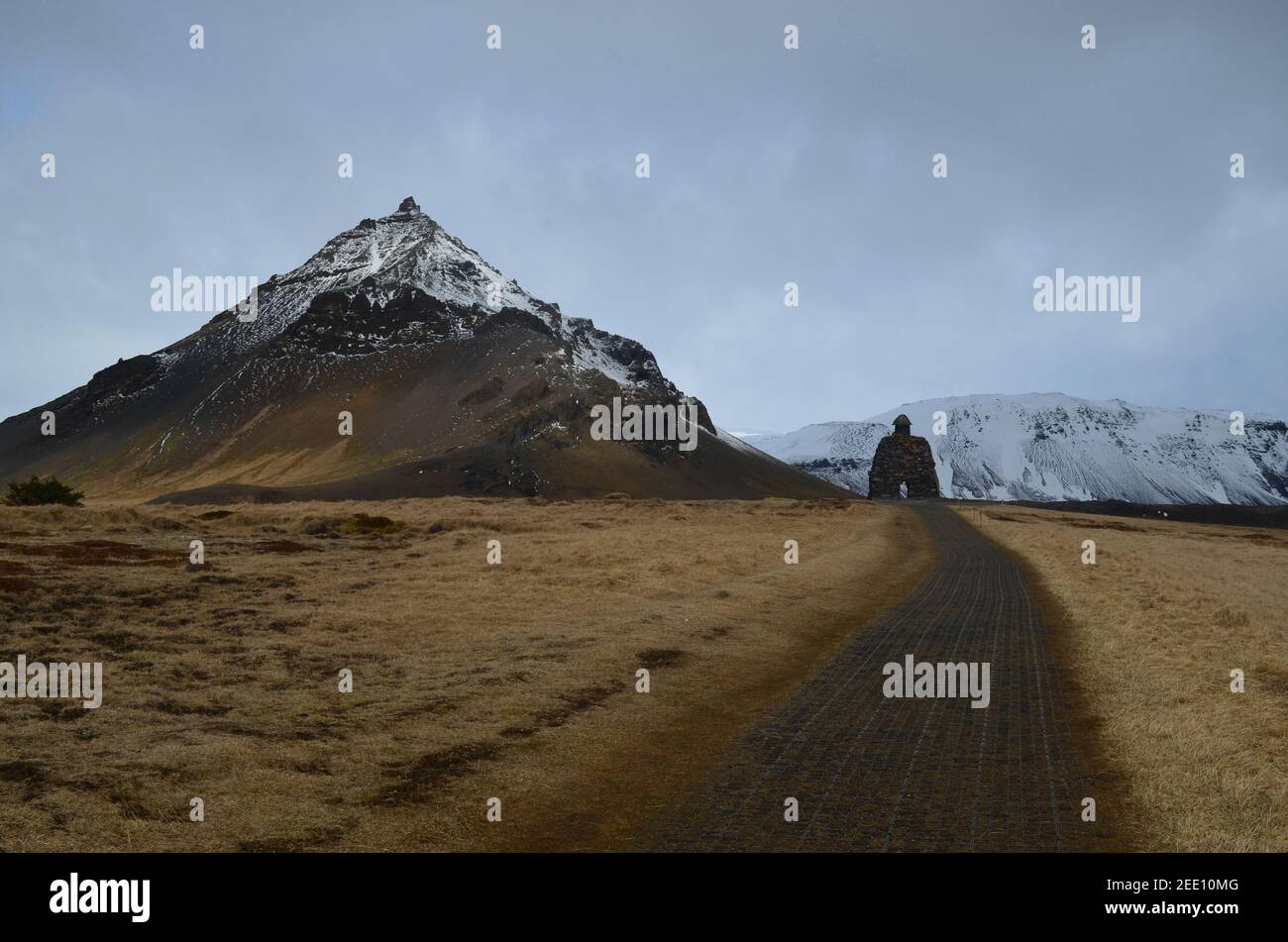 Rural rugged dirt road heading into the fishing village of Arnarstapi ...
