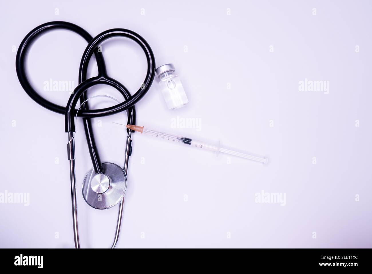 Doctor blue stethoscope for cardiac on white background with syringe ...