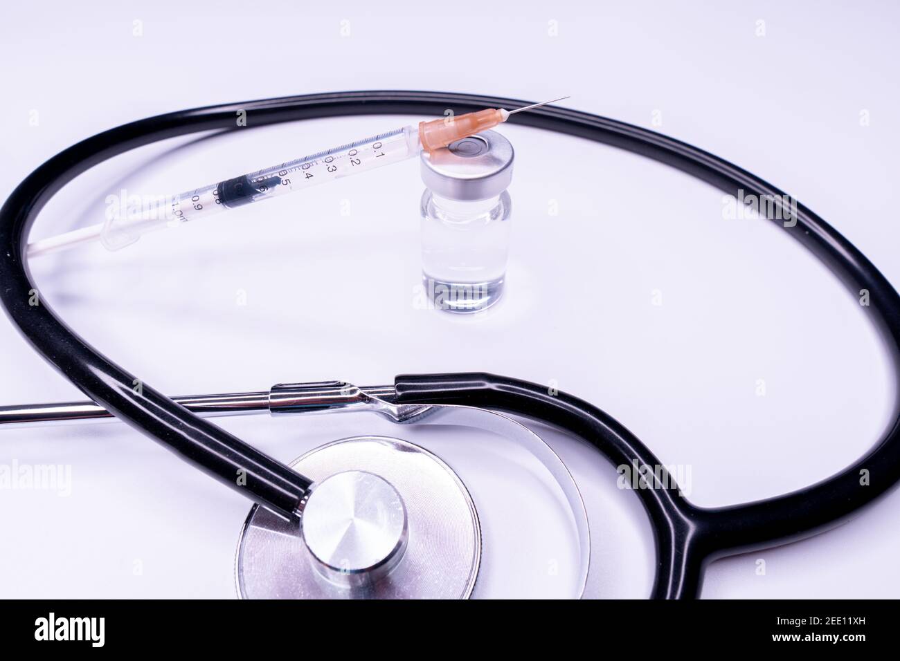 Doctor blue stethoscope for cardiac on white background with syringe ...