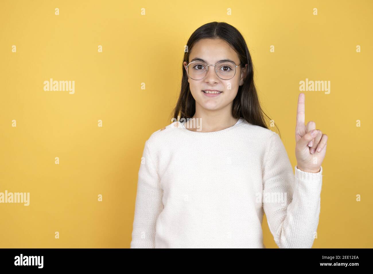 Beautiful child girl wearing casual clothes showing and pointing up ...