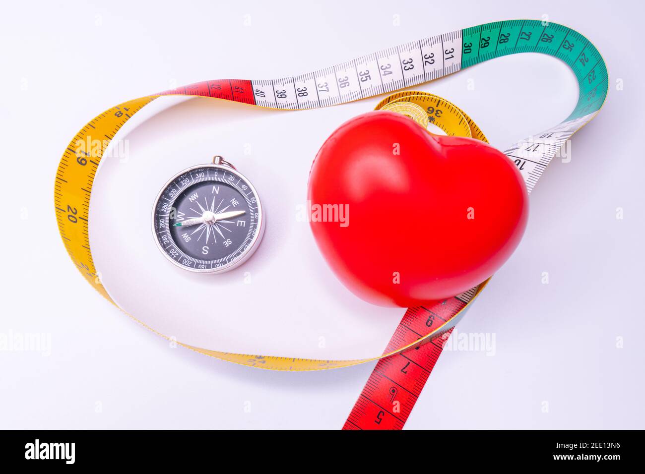 Top view red heart shape and white measurement tape on white background ...