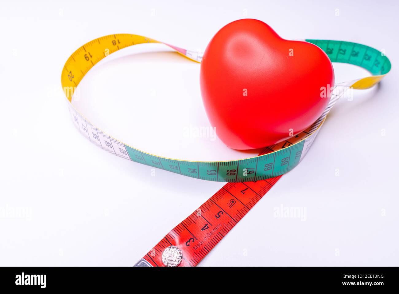 Top view red heart shape and white measurement tape on white background ...