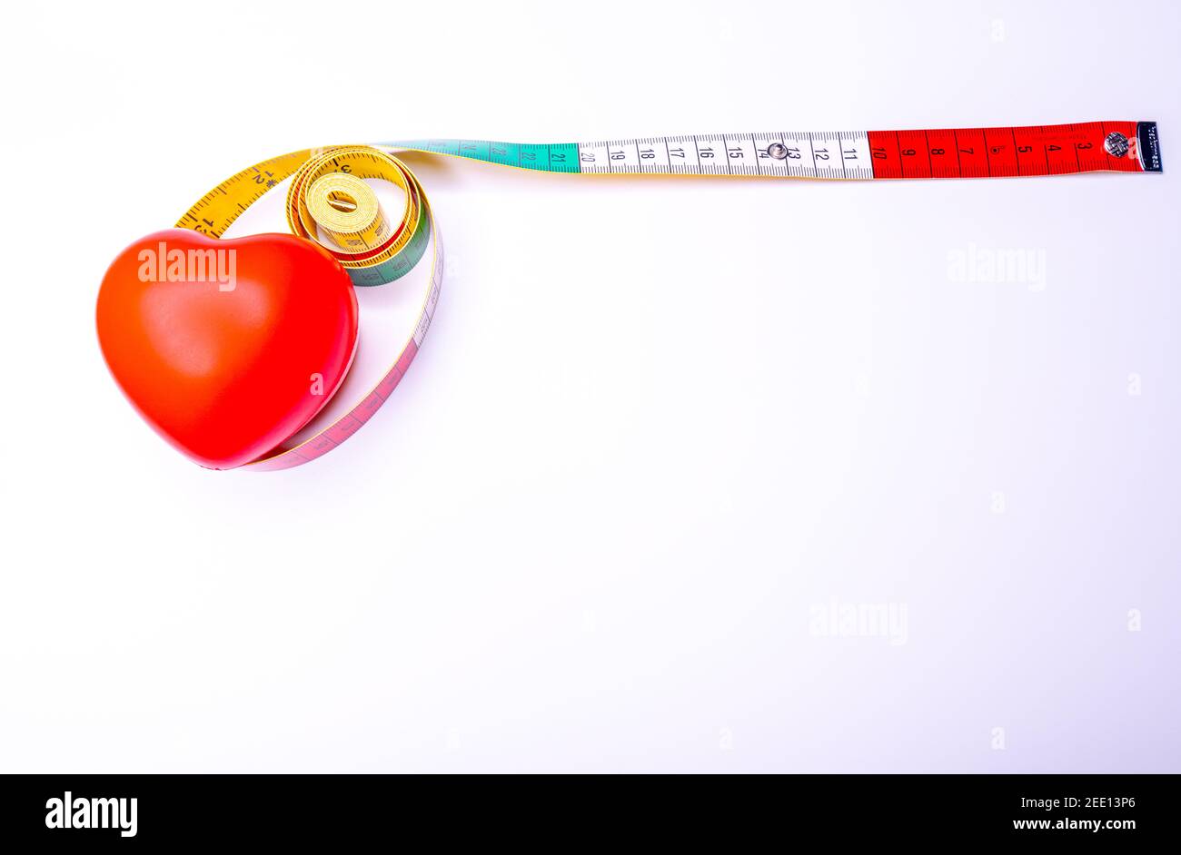 Top view red heart shape and white measurement tape on white background ...