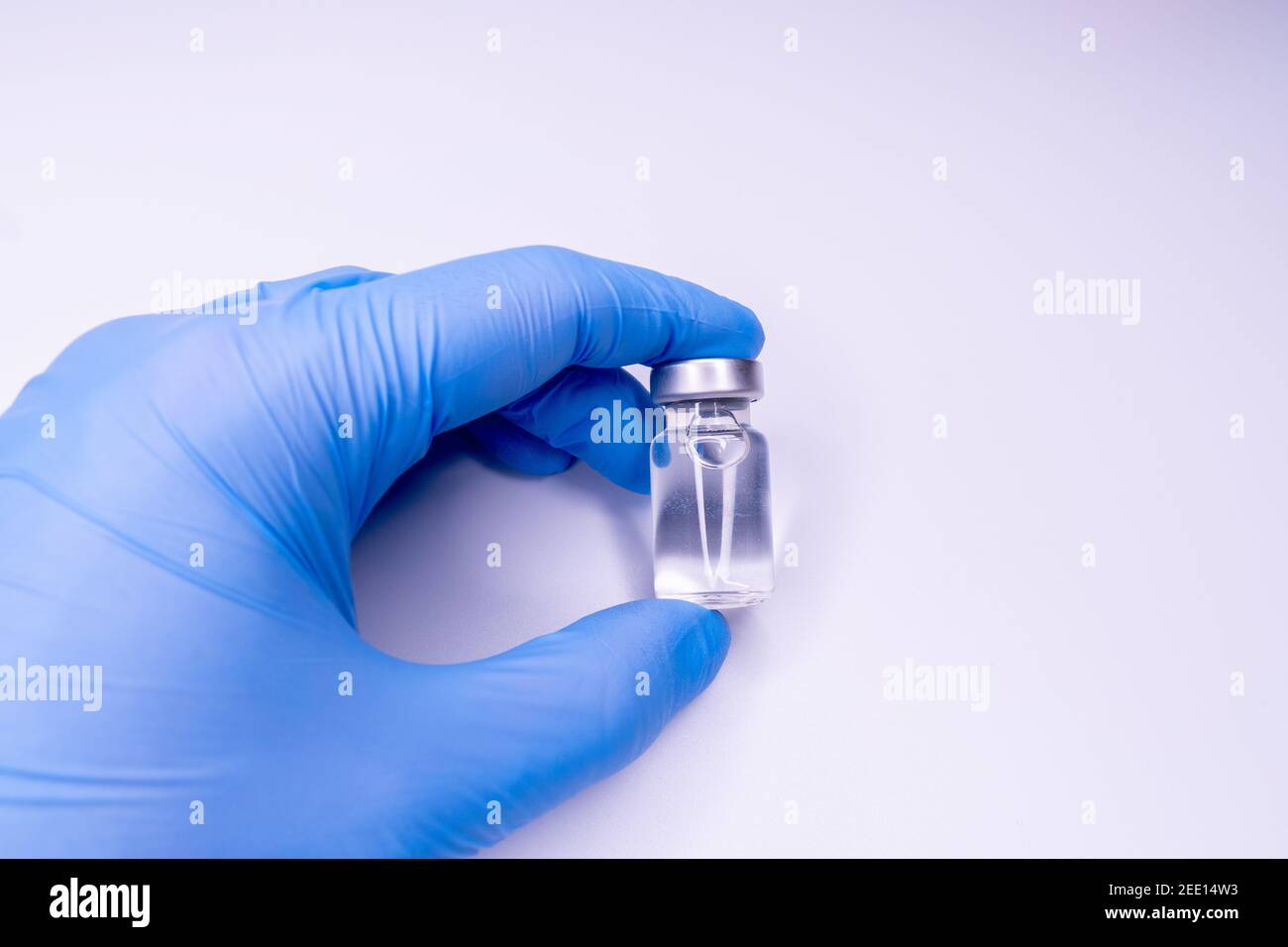Medicine bottle for injection in hand, palm of a doctor. Medical glass ...