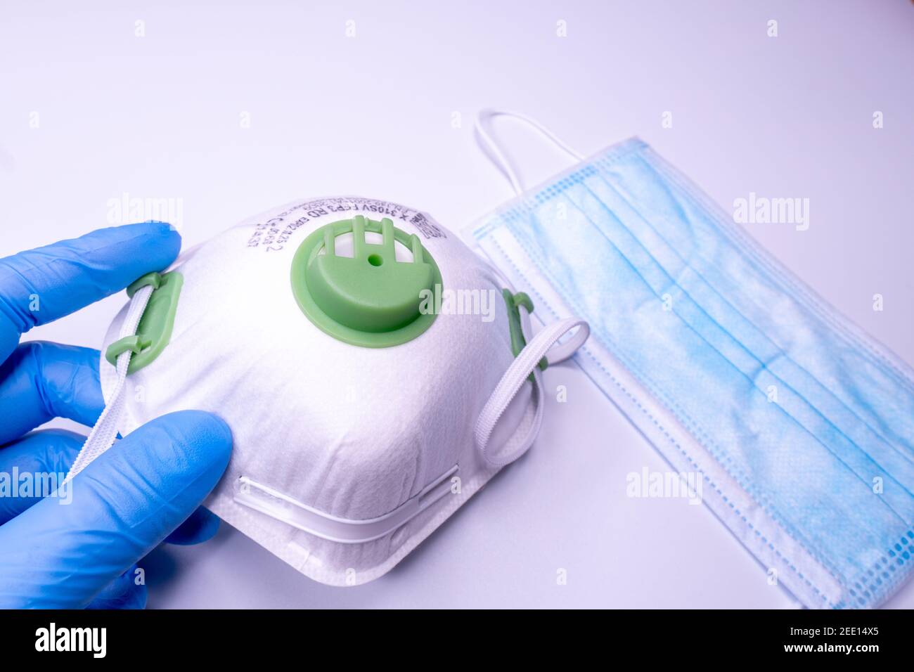 Medical bottle, vials, syringes and face mask on blue background with ...