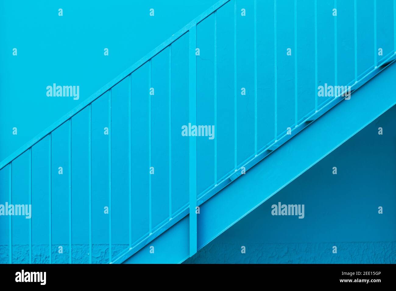 Metal blue staircase with blue railing on a blue wall Stock Photo - Alamy