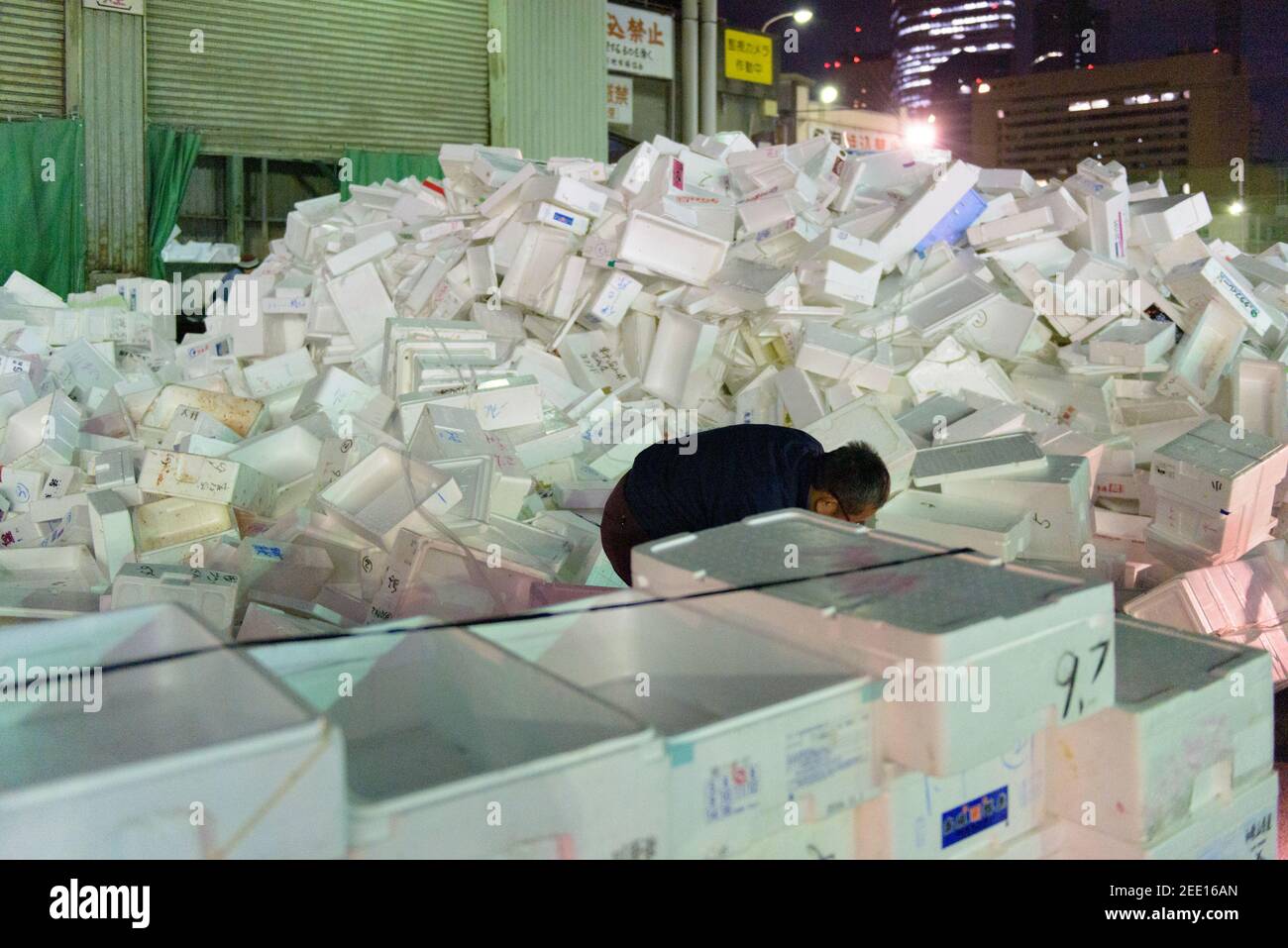 Tokyo, Japan - Jan 22 2016: Workers sort through a mountain of white ...