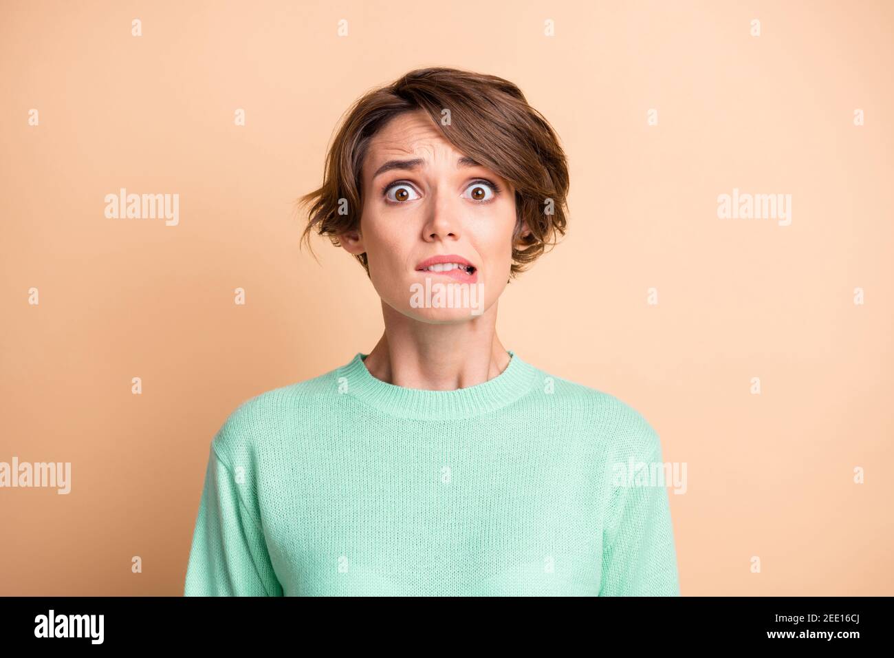 Portrait of young beautiful scared afraid frightened girl bite lips ...