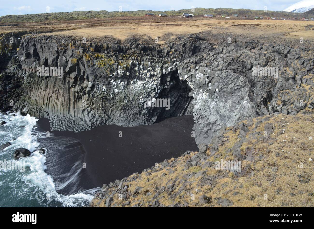 Basalt columns and black sand beach with waves crashing ashore Stock ...