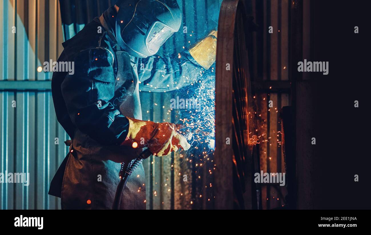 Professional welder performs welding hi-res stock photography and ...