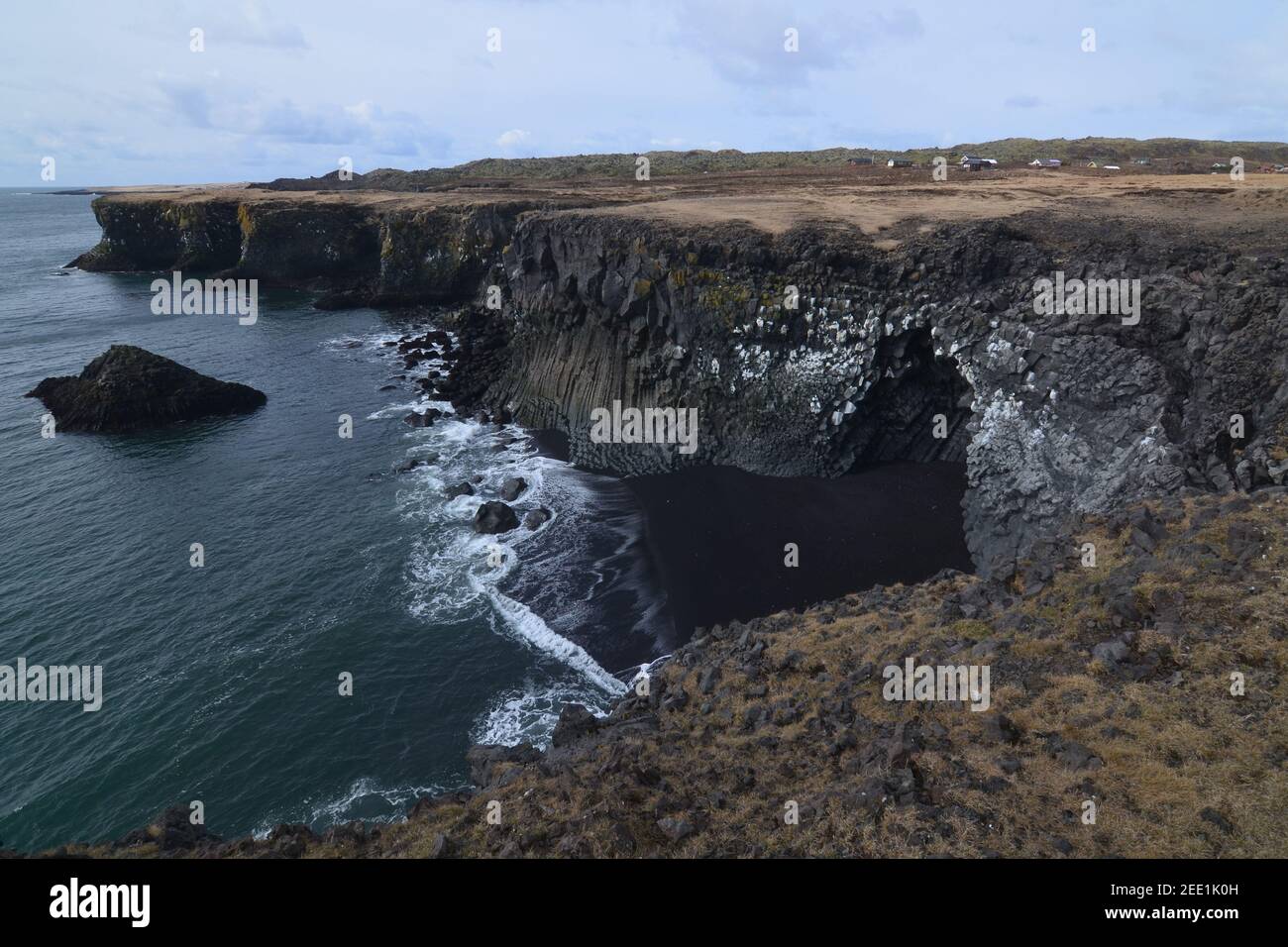 Lovely rock cliffs and basalt column rocks and sand beach Stock Photo ...