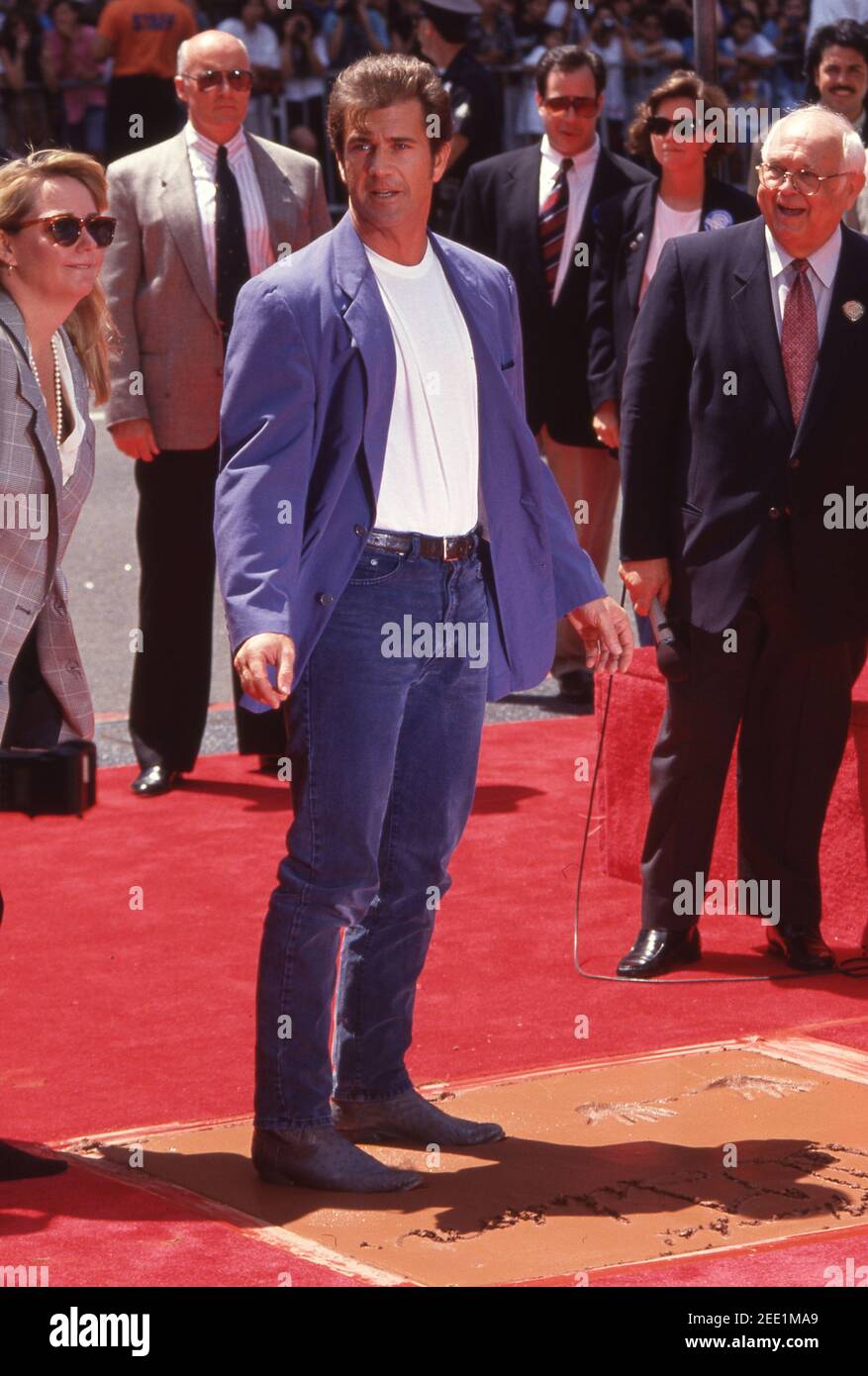 Mel Gibson places his hand and footprints in cement on August 23, 1993 ...