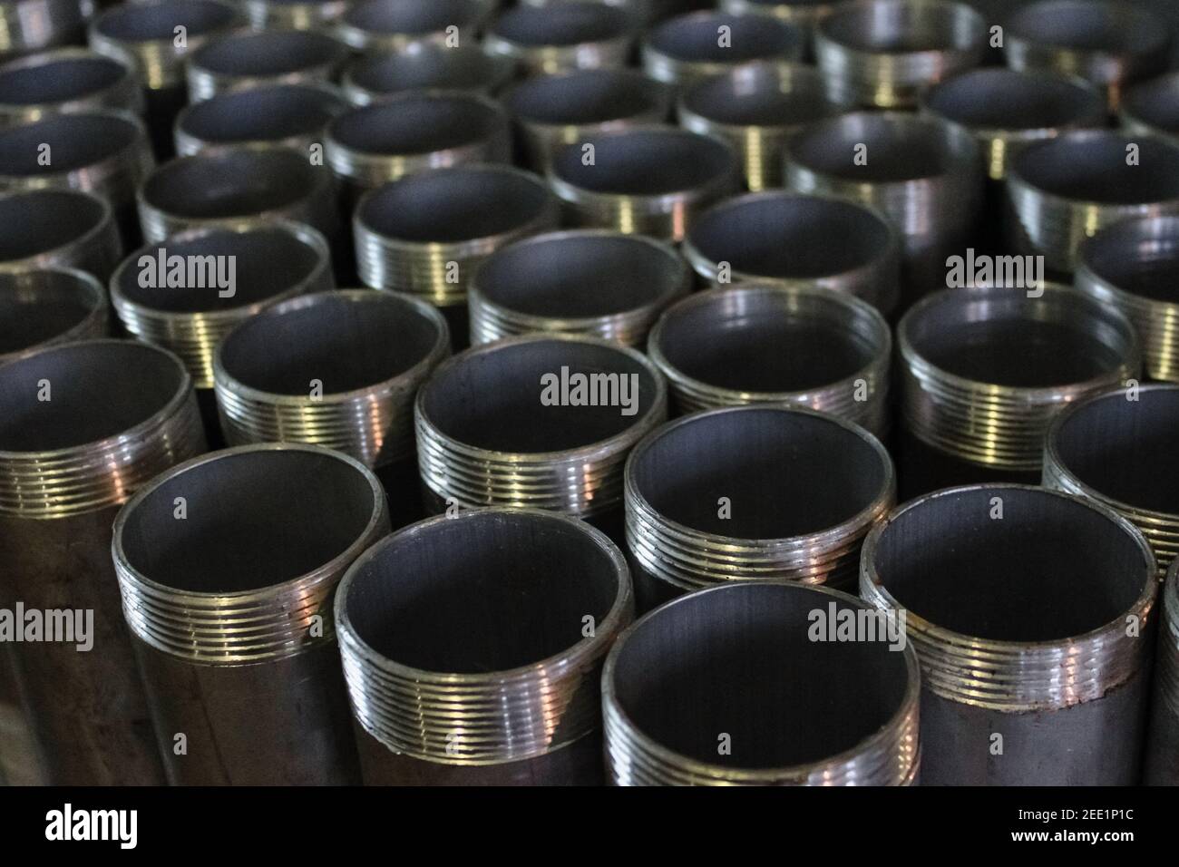 Steel pipes with threads in a production warehouse Stock Photo - Alamy