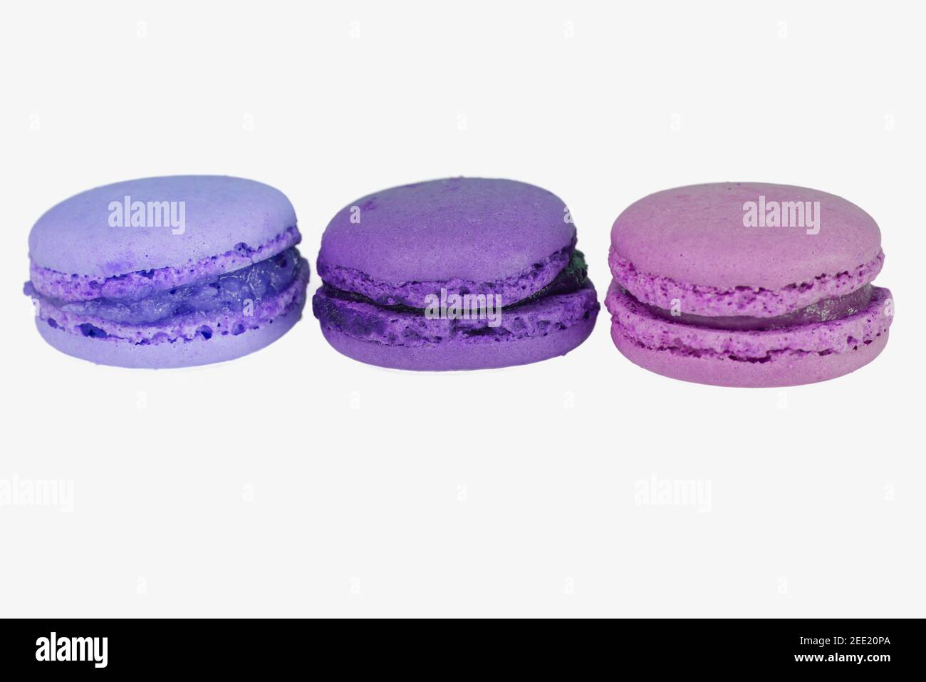 three macaroons in blue, violet and purple, isolated on white ...