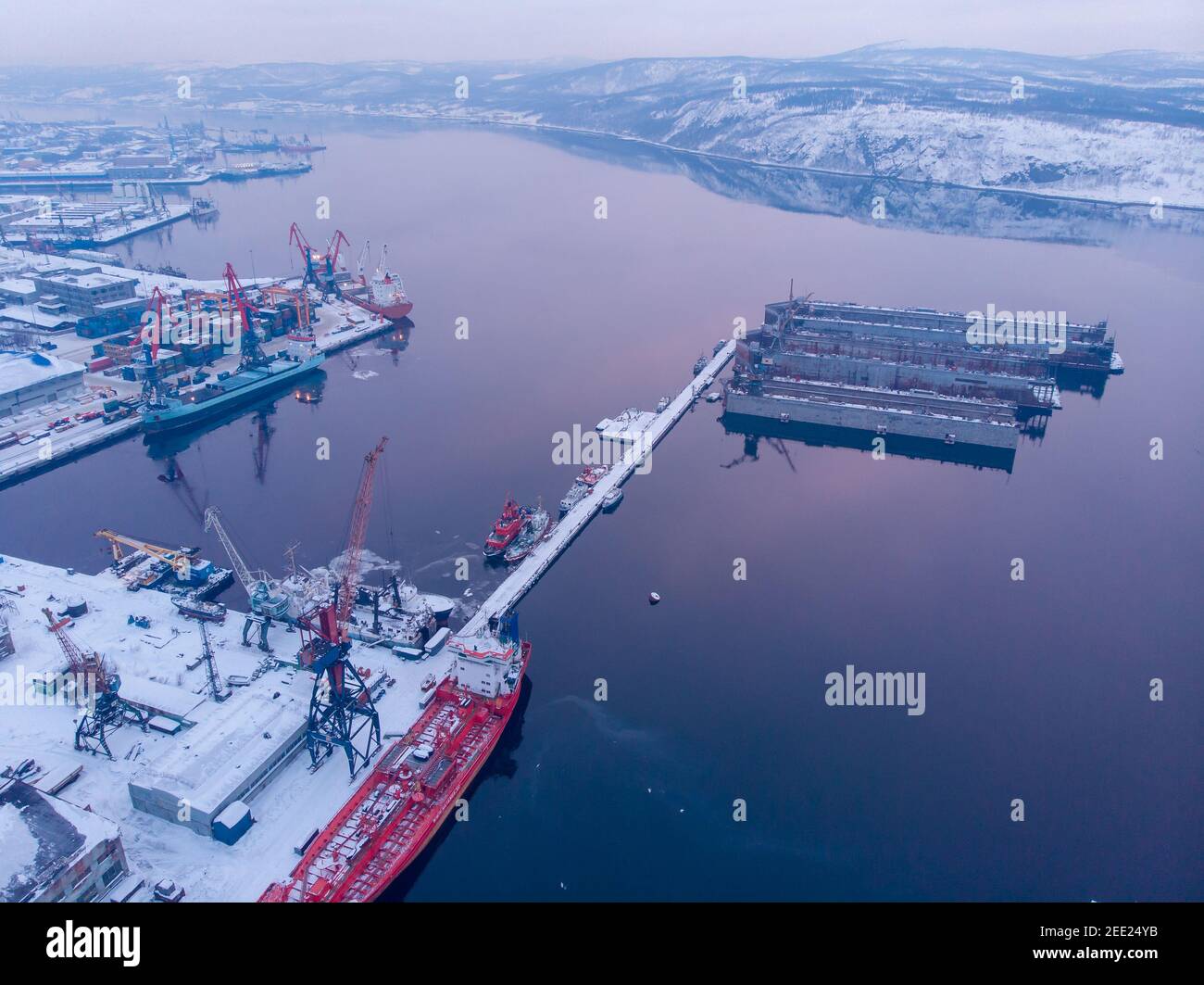 Container cargo ship loading North Arctic port. Concept freight ...