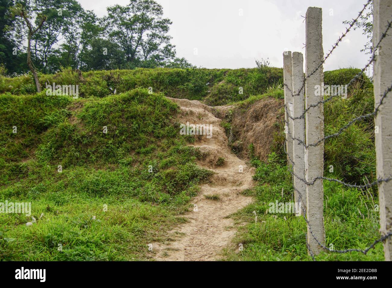 Landscape of a field with stone pillars and barbed wire fence Stock ...