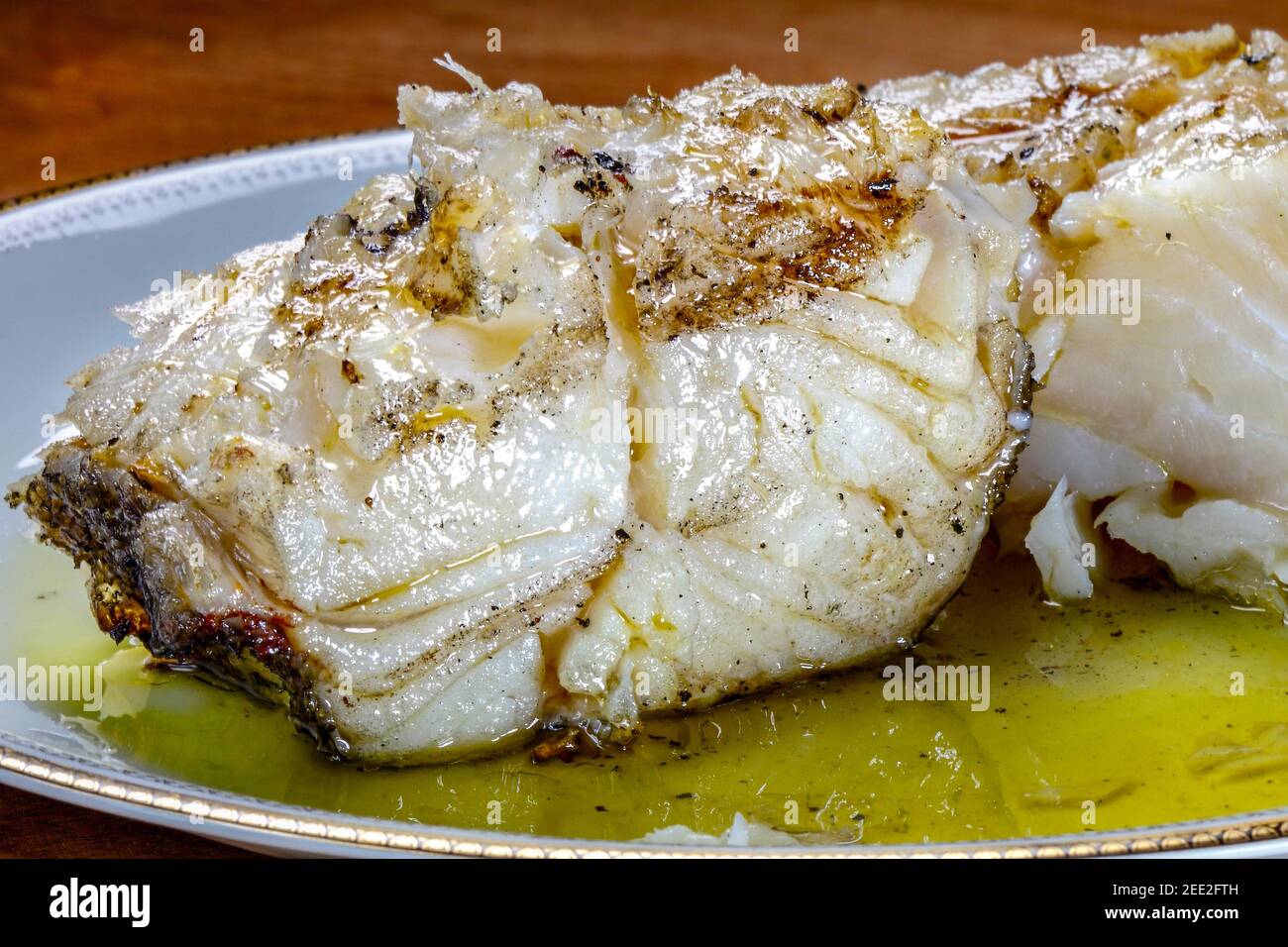 Baked cod with olive oil Stock Photo - Alamy