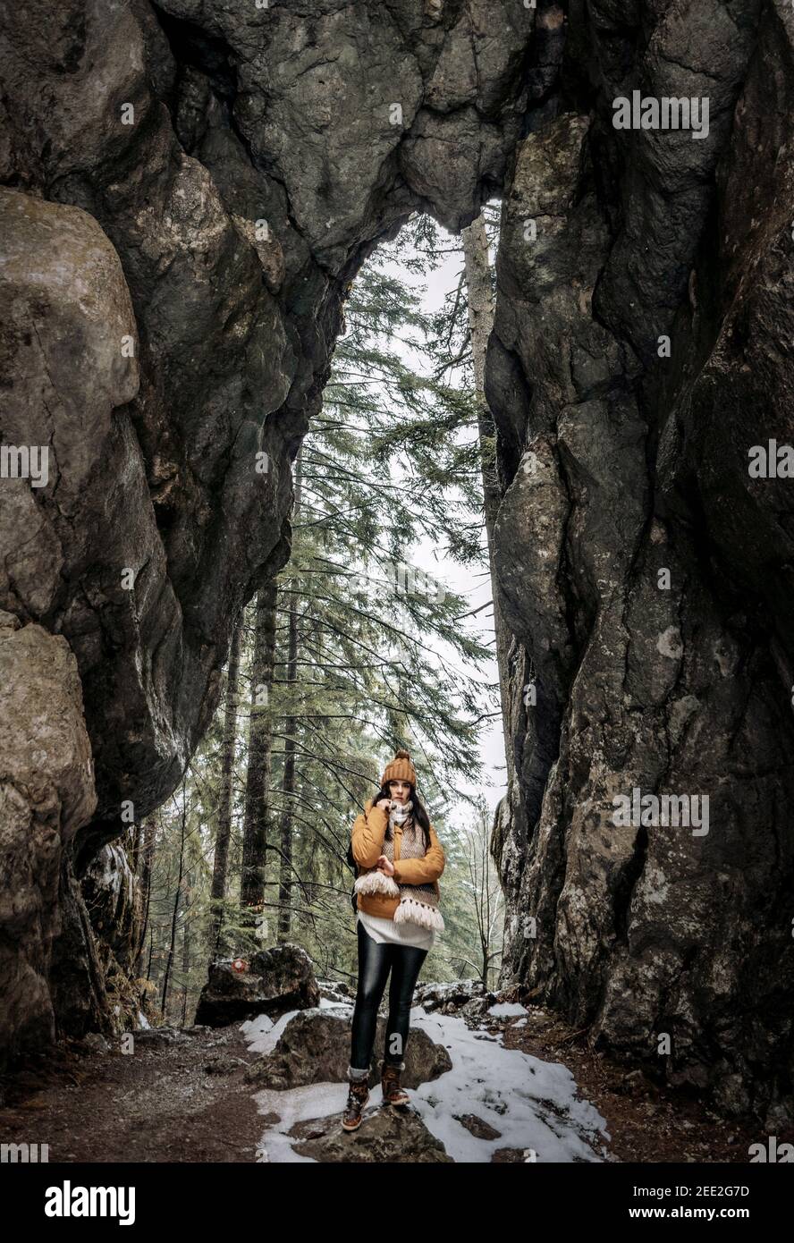 Woman standing under rock arch hi-res stock photography and images - Alamy