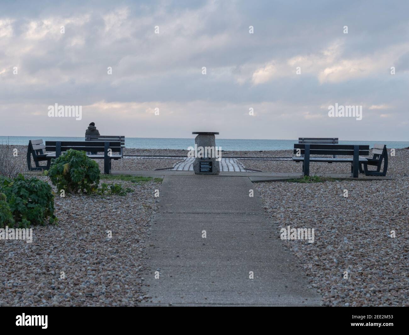 Path leading to a seating area with benches and a view of the sea Stock ...