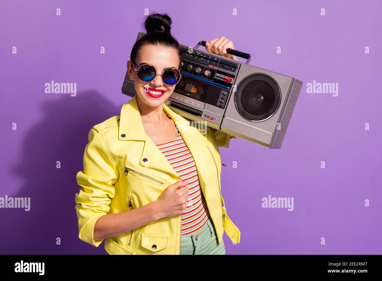 Photo of positive youngster lady hold shoulder boom box isolated over ...