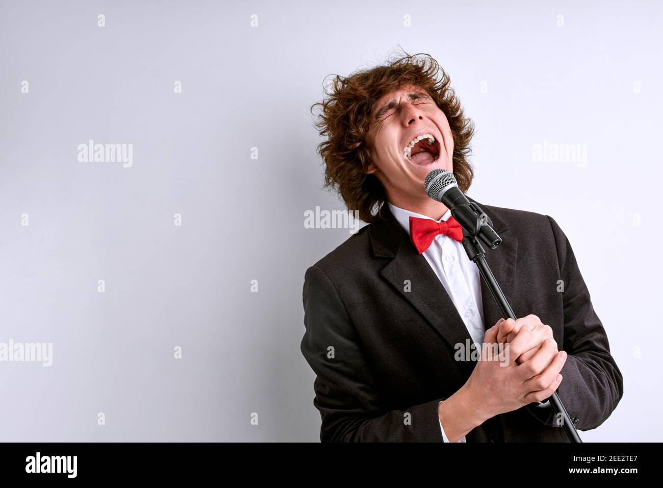 singer man at performance singing on microphone, expressive artist ...