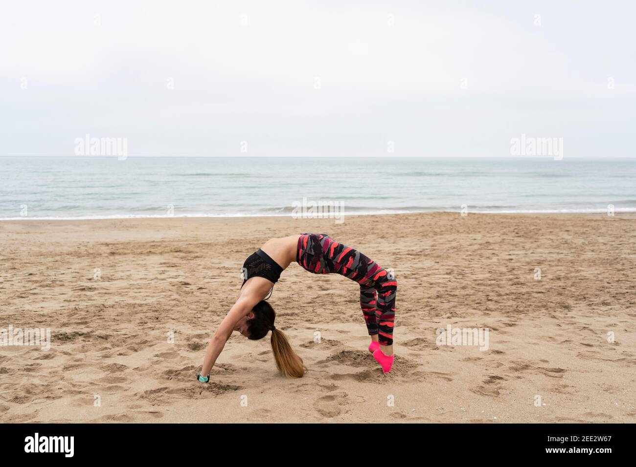 Athletic Fitness Woman Practicing Wheel Pose Chakrasana Or Urdhva