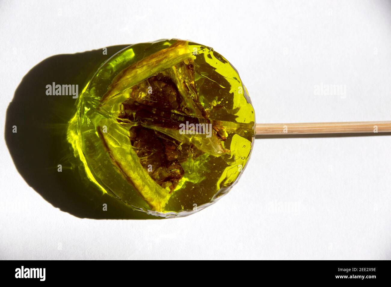 Yellow lollipop with lemon slice inside on white background Stock Photo ...