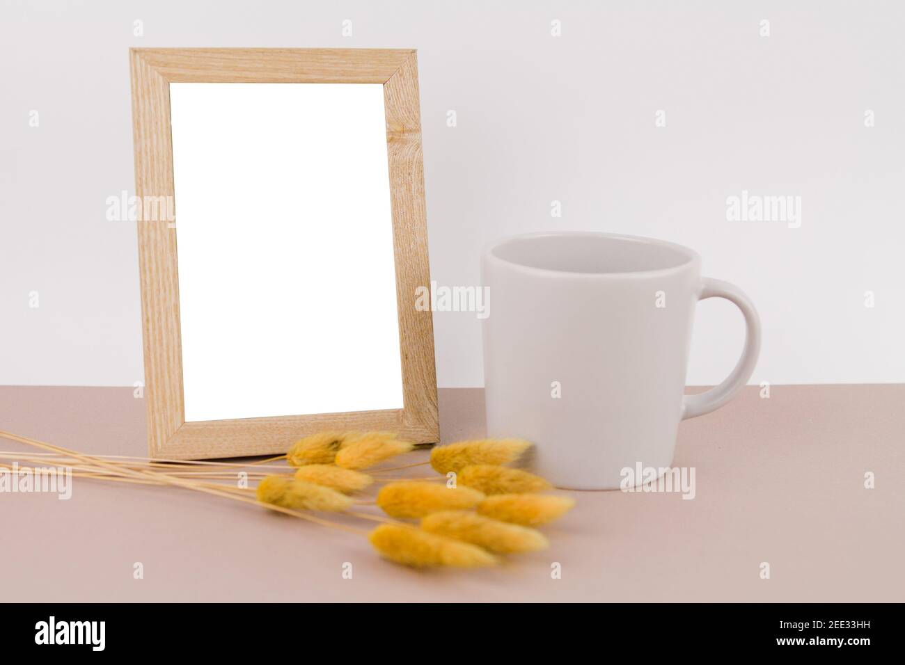 a photo frame on the table with a cup and spikelet Stock Photo - Alamy