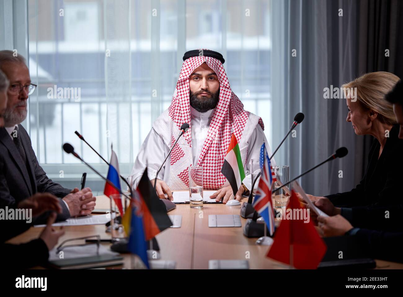 Arabic sheikh man presenting his ideas to diverse multi-ethnic ...