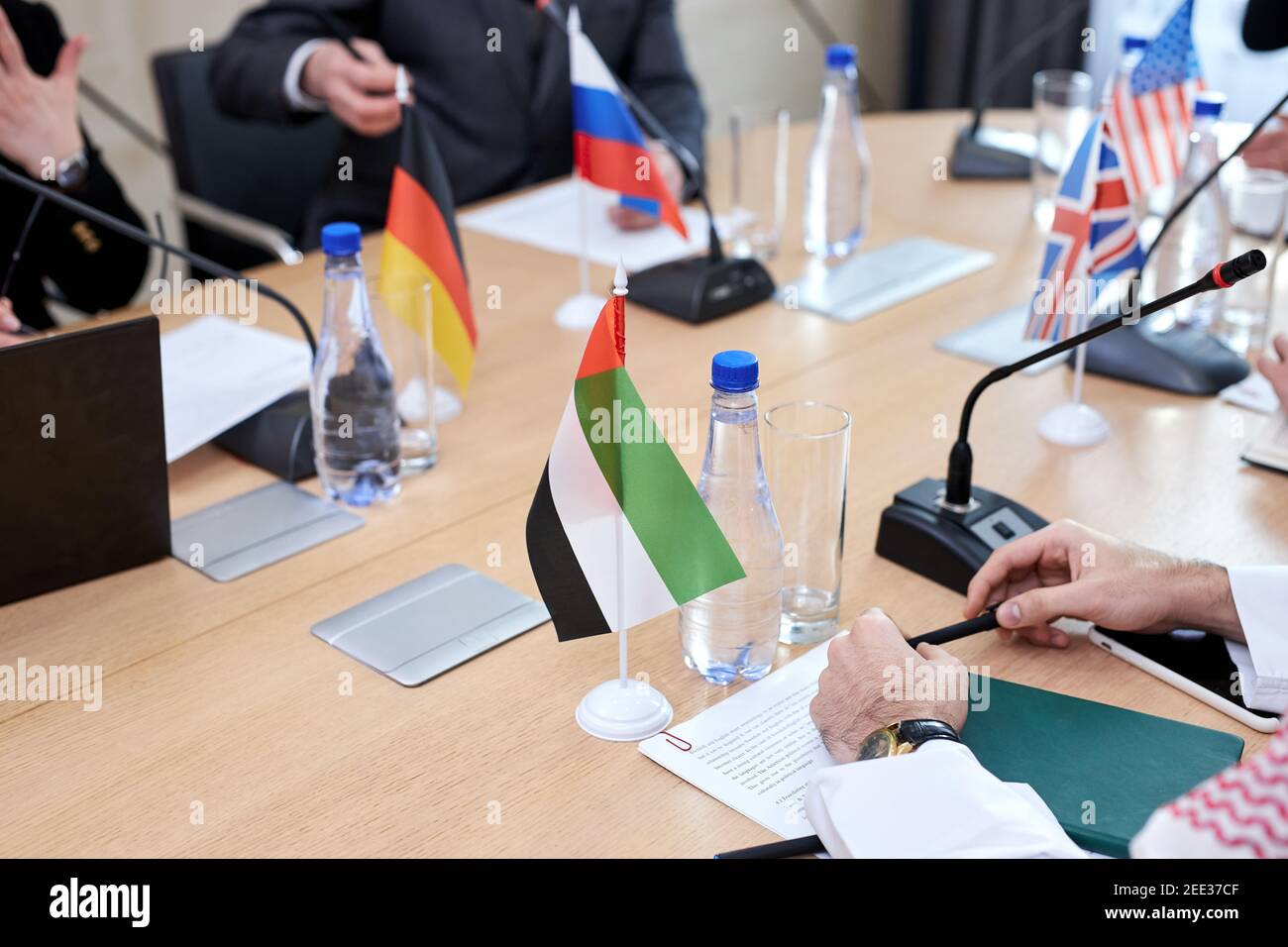close-up photo of table and different flags, international summit ...
