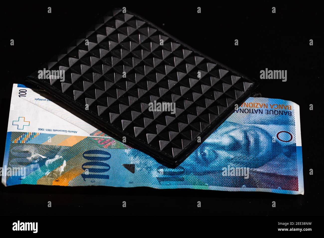 100 swiss franc banknote in a black wallet isolated Stock Photo - Alamy