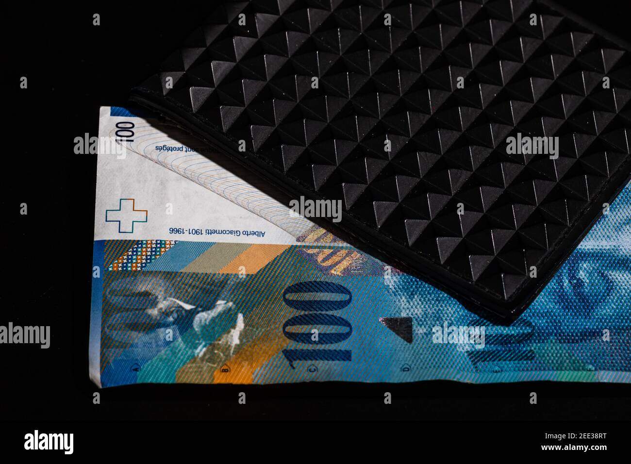 100 swiss franc banknote in a black wallet isolated Stock Photo - Alamy
