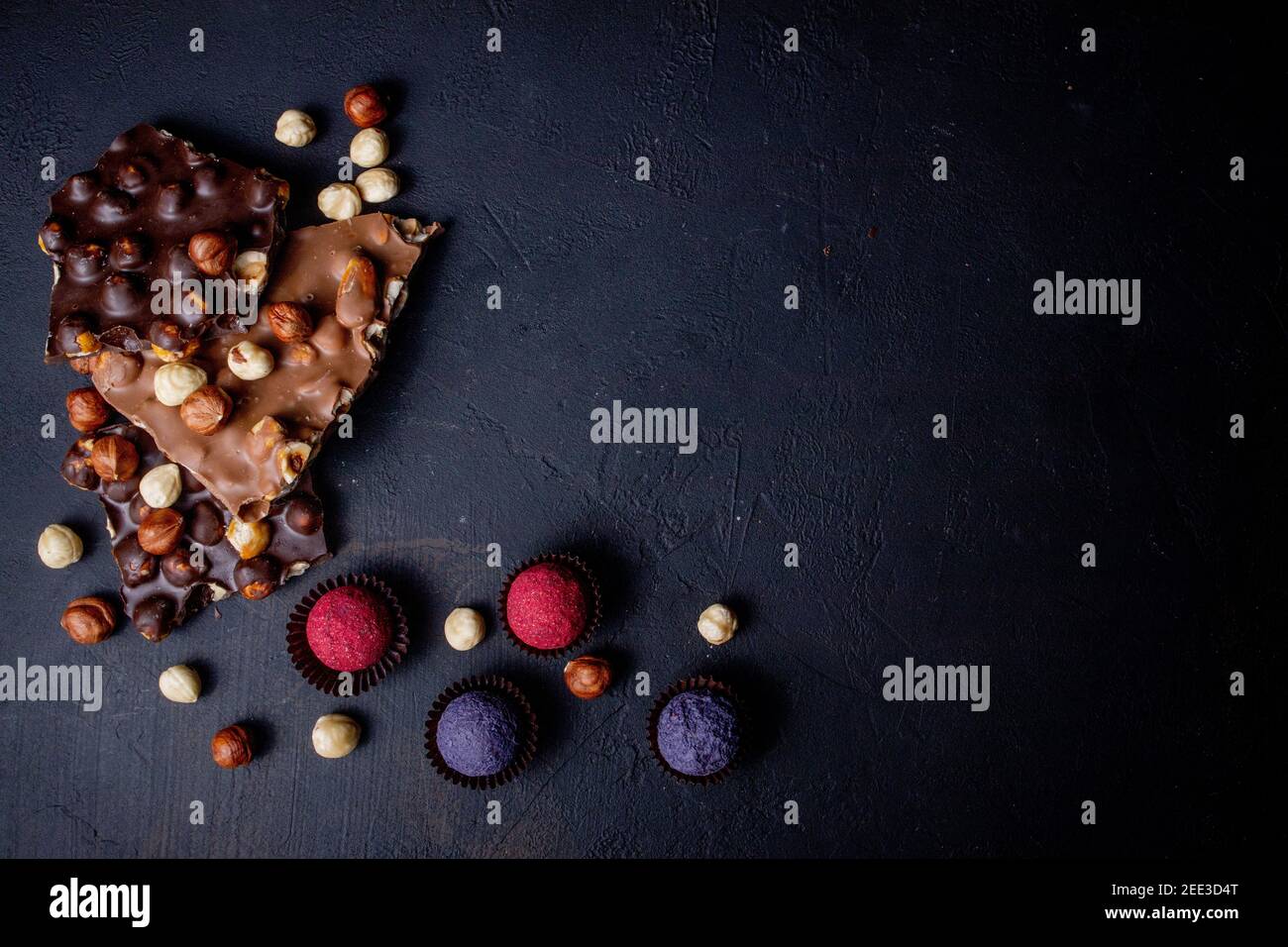 Chocolate candy truffle with chocolate pieces and flying cocoa powder ...