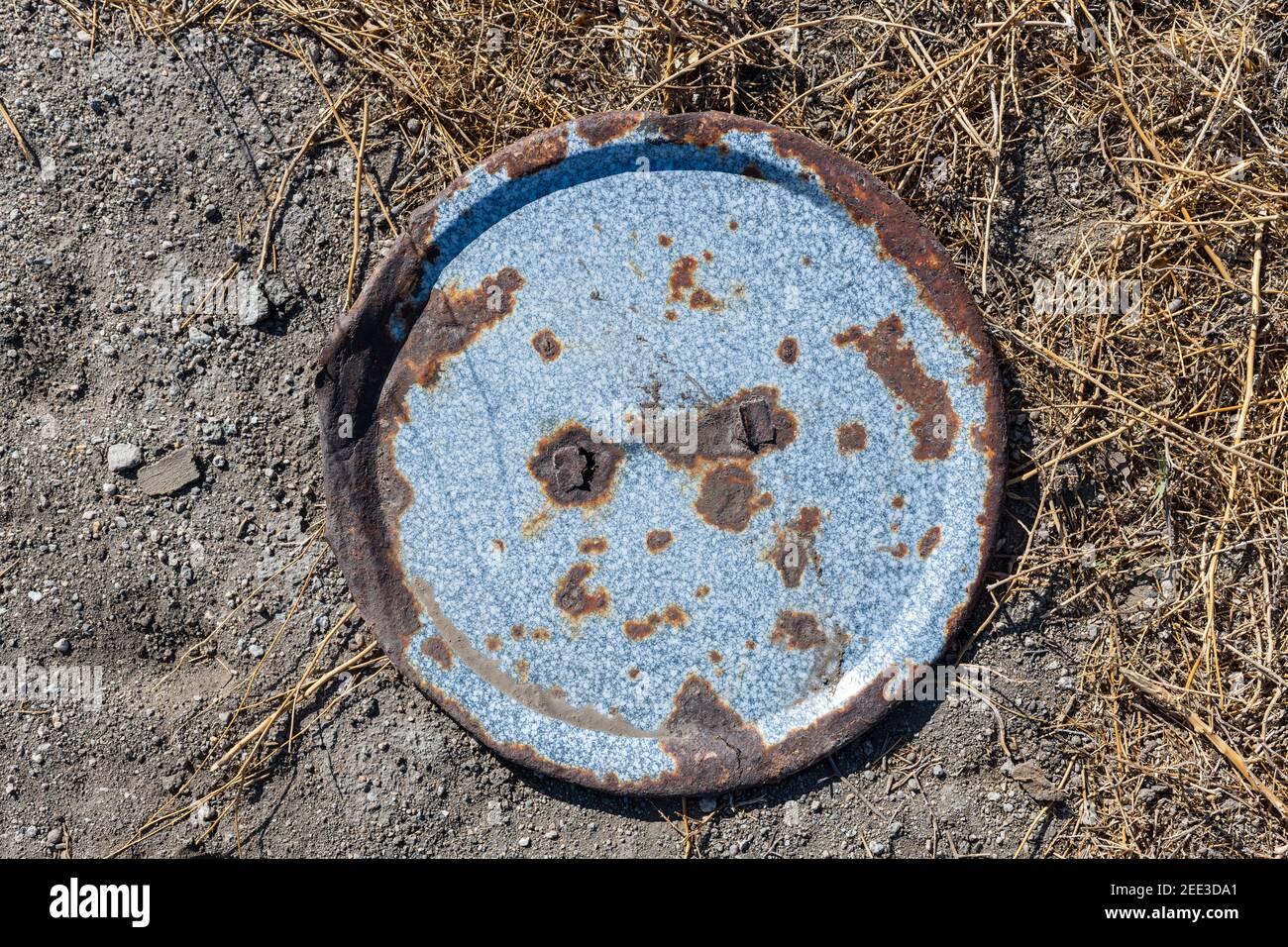 A rusty lid abandoned on the ground Stock Photo - Alamy