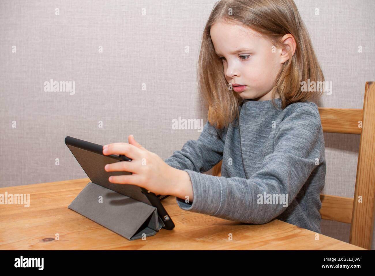 little girl is watching an online video tutorial. Remote training. Blog ...