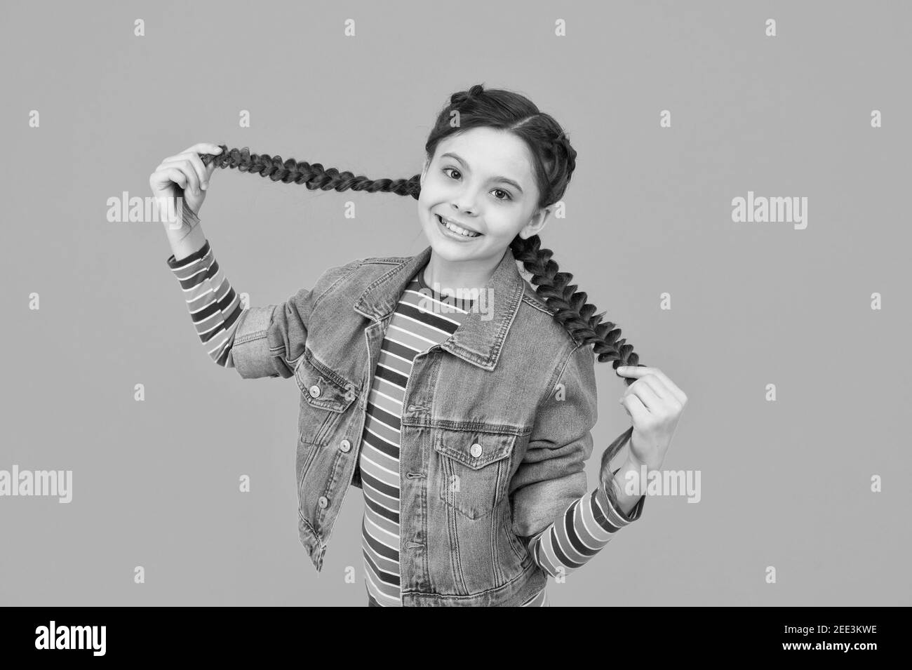 Happy little girl with braids wear denim clothes, modern style concept ...