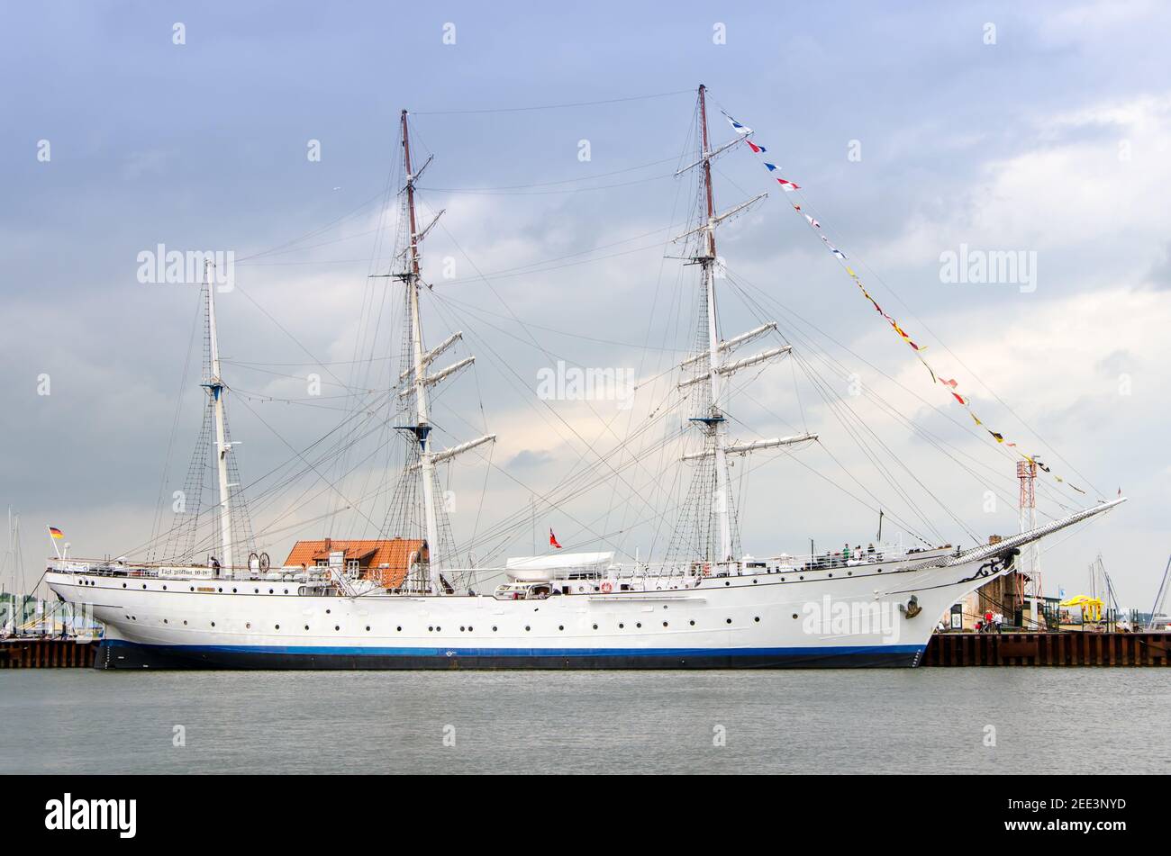 White sailing ship on the background of the cloudy sky Stock Photo - Alamy