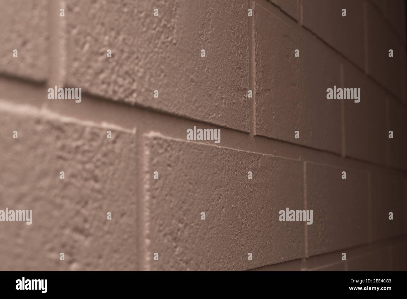 Decorating the wall with brick-shaped plaster. Beige wall, selective ...