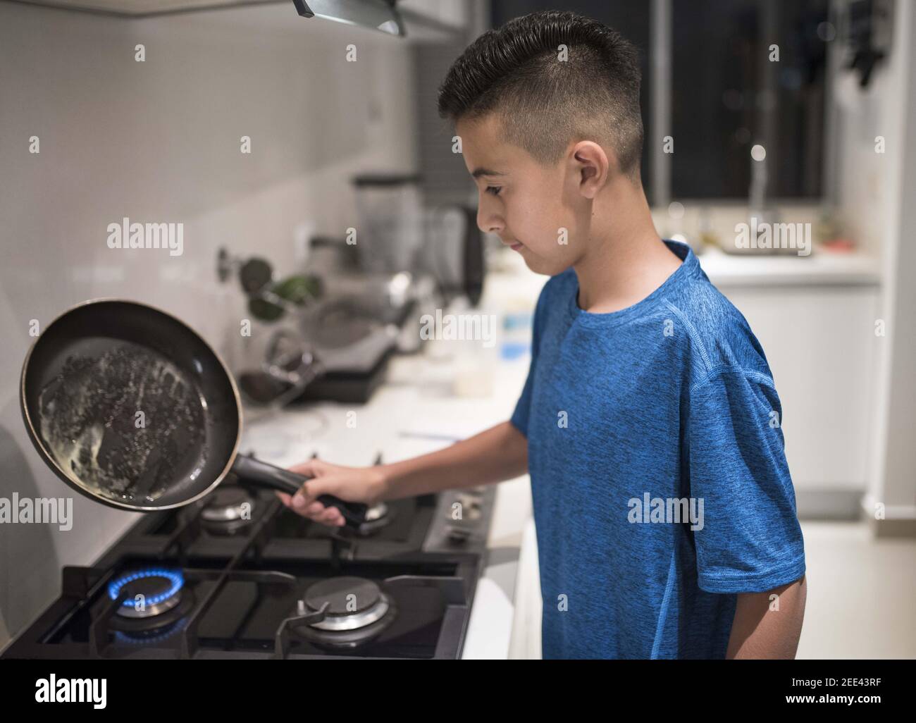Little boy cooking in the kitchen Stock Photo - Alamy