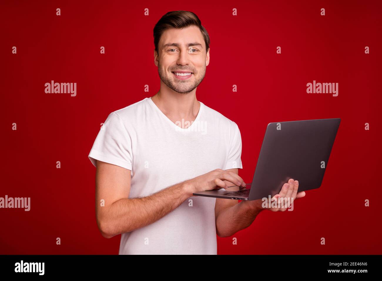 Photo portrait of young programmer working with computer typing texting ...