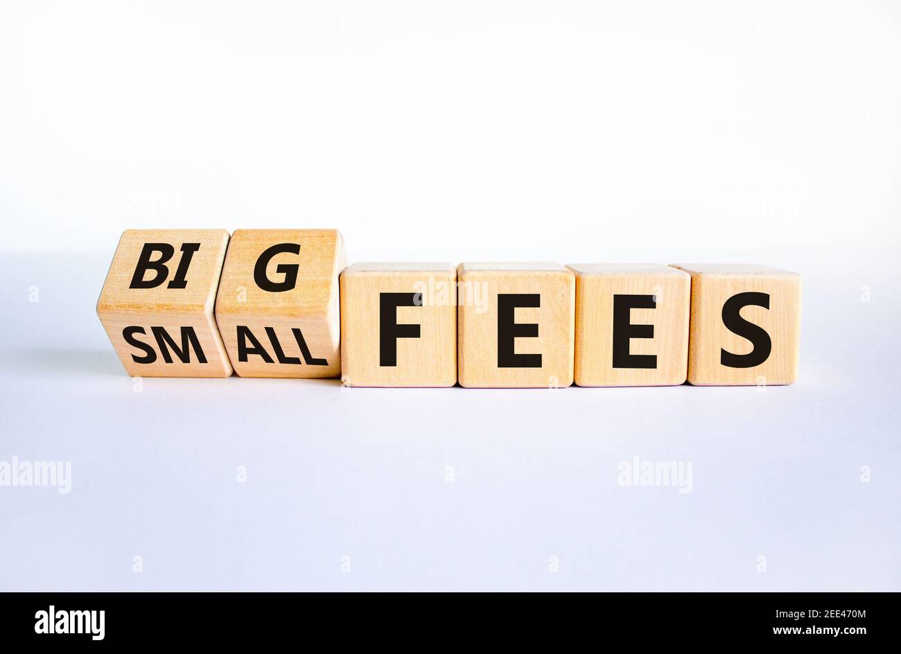 Big or small fees symbol. Turned wooden cubes and changed words 'small ...