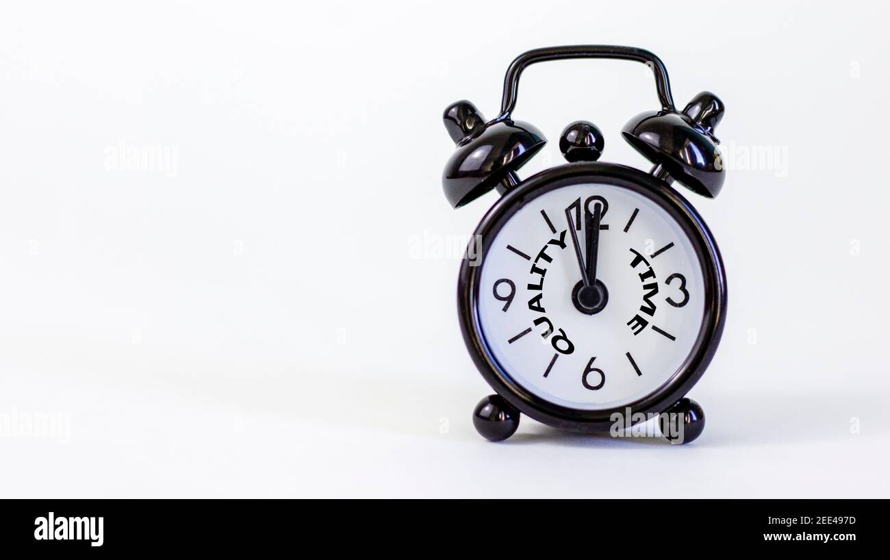 Quality time symbol. Beautiful black alarm clock with words 'quality ...