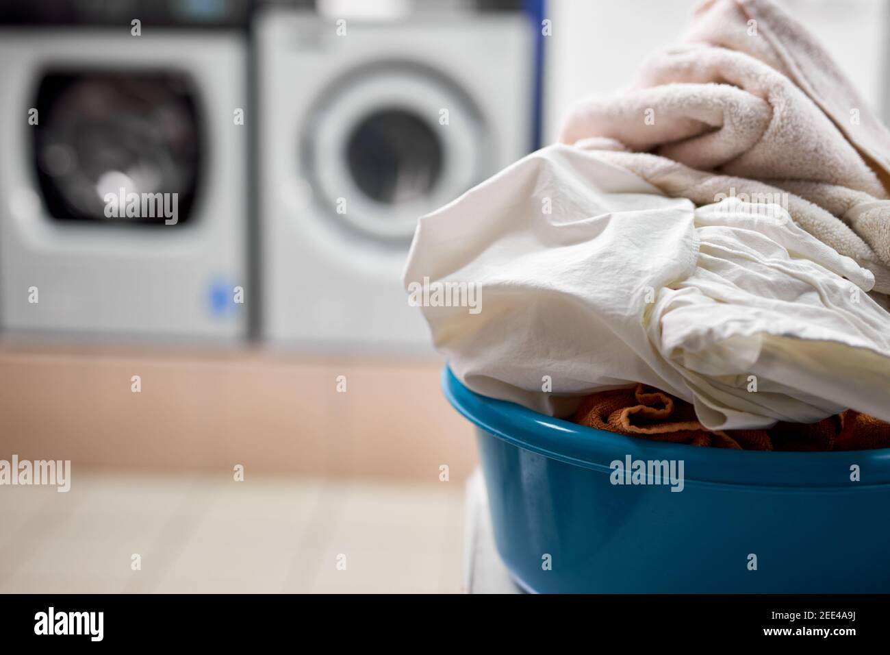 close-up photo of basin with dirty clothes to be washed in washing ...