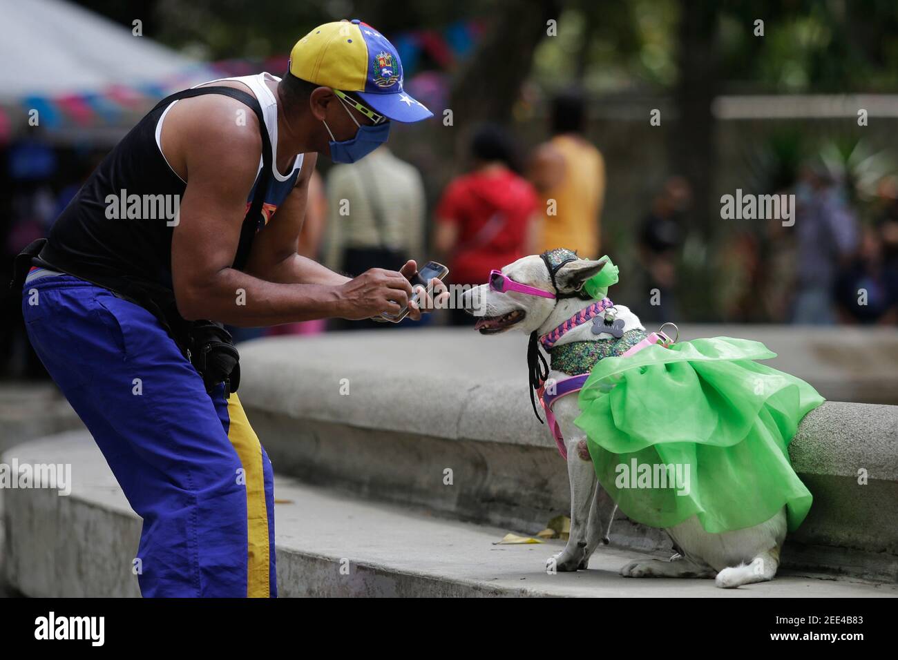 Caracas, Venezuela. 15th Feb, 2021. A man takes a photo of his dog ...
