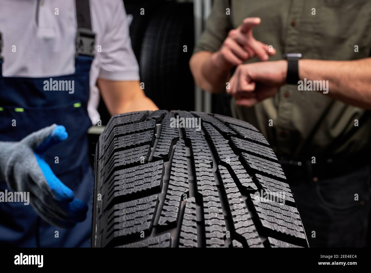 close-up photo of car tire, focus on black tire, customer examining the ...