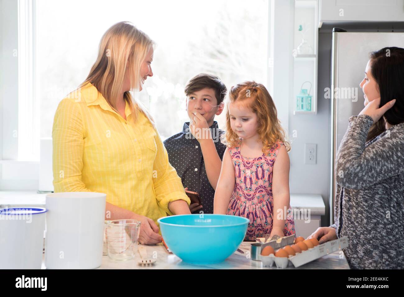 Mom and kids baking in the kitchen Stock Photo - Alamy